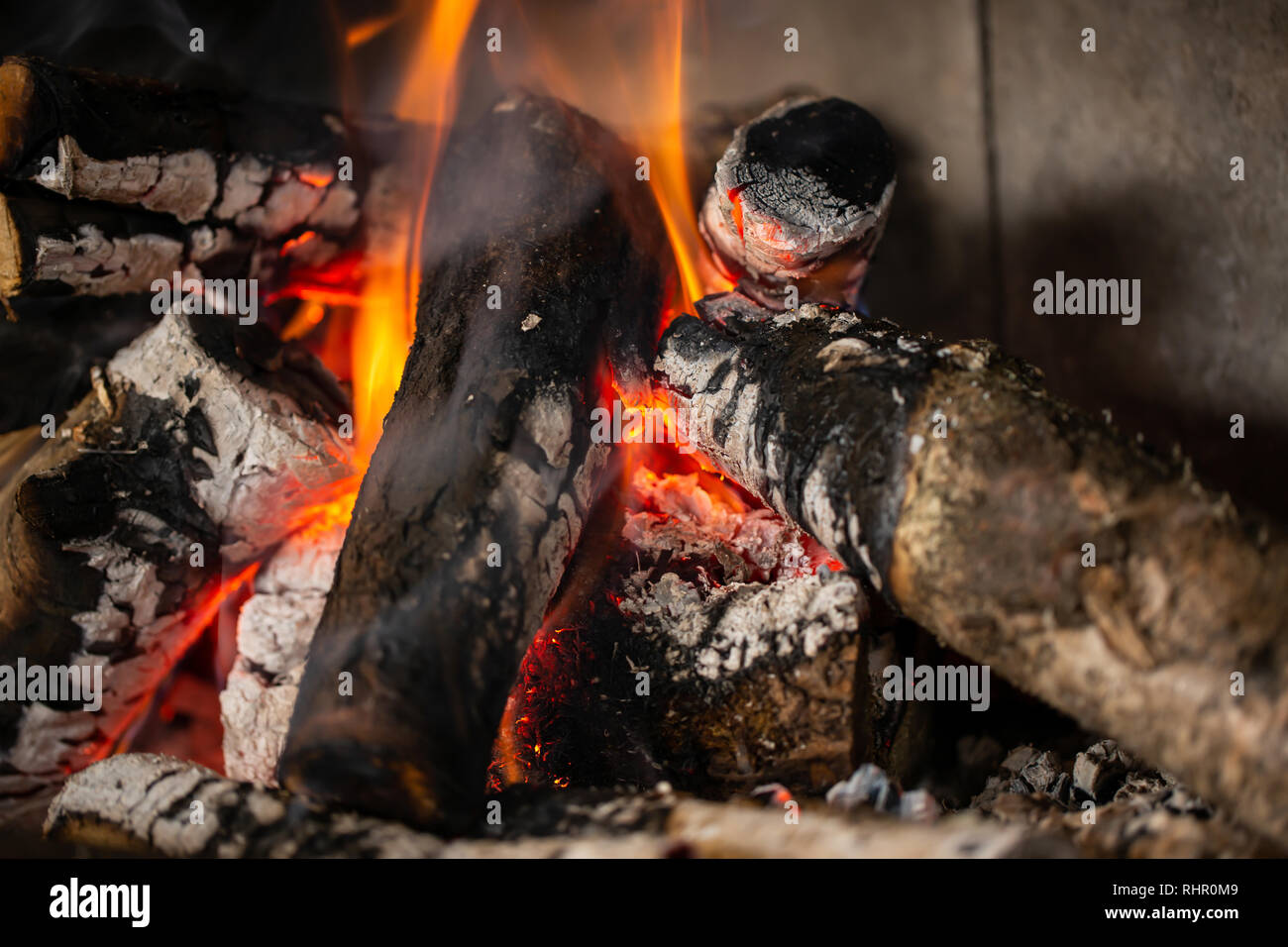 A fire is burning in the fireplace, slowly coal is being produced Stock ...