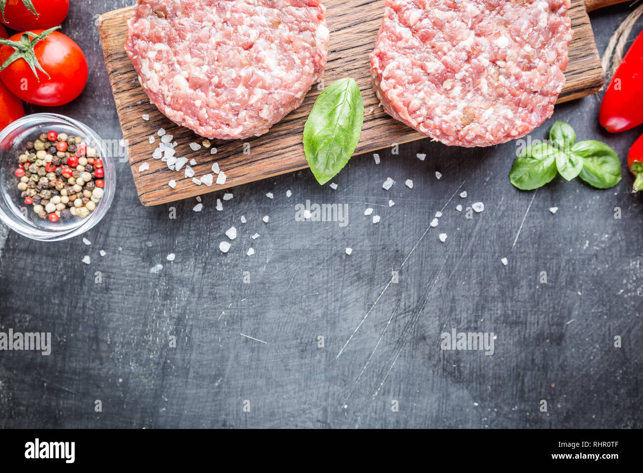 Fresh raw Prime Black Angus beef burger patties on black background ...