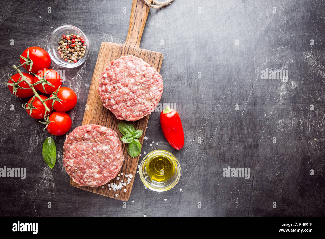 Fresh raw Prime Black Angus beef burger patties on black background ...