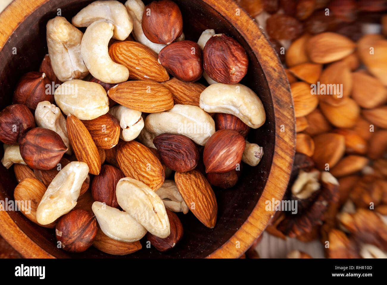 Peeled hazelnut, cashew, almond in a wooden cedar plate on the ...