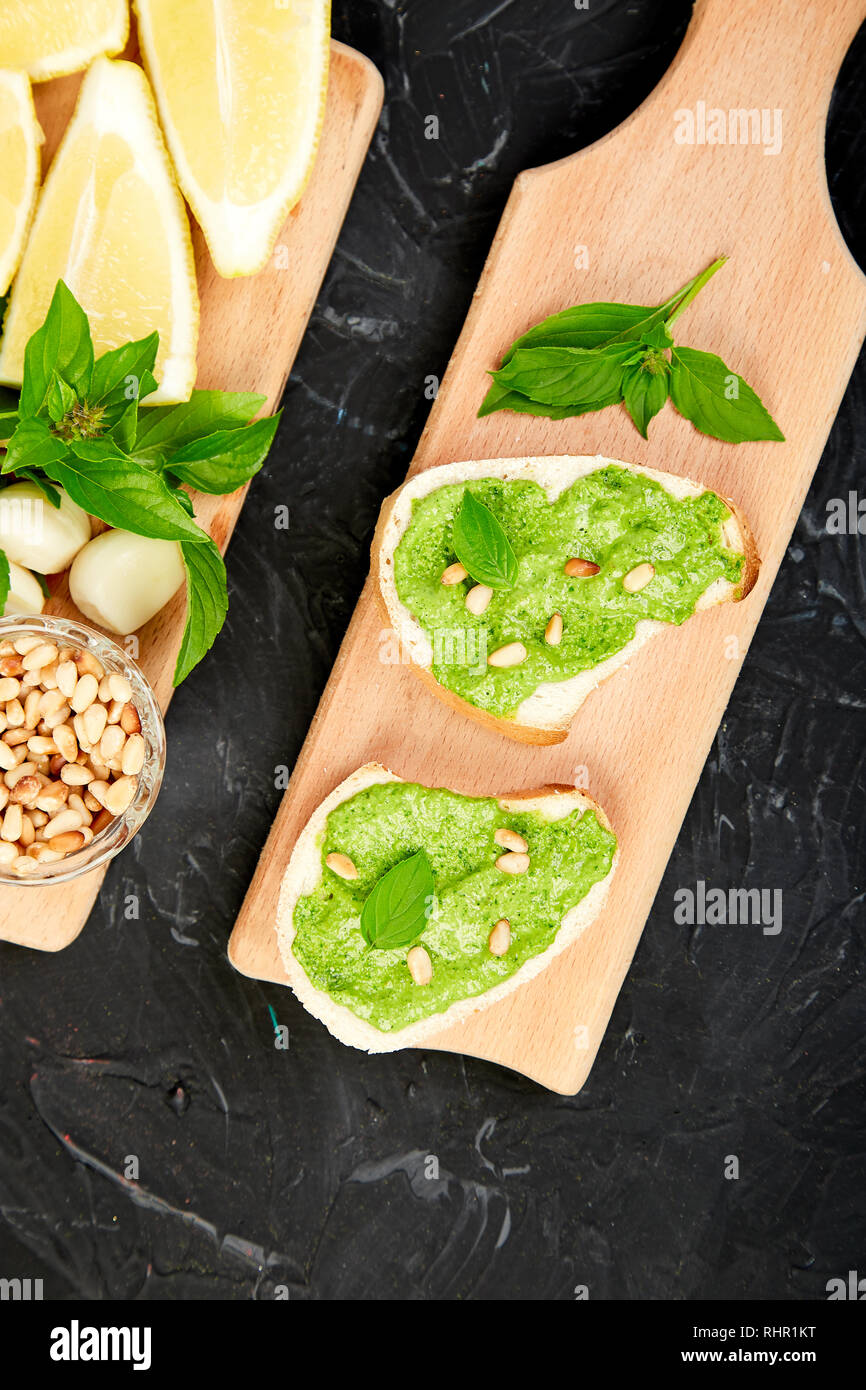 Bruschetta bread with pesto sauce, parmesan cheese and fresh basil ...