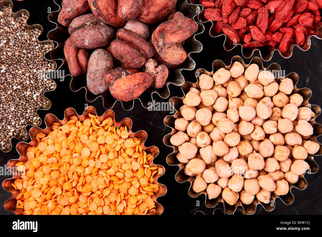Various superfoods in small bowl on blackbackground. Superfood as chia ...