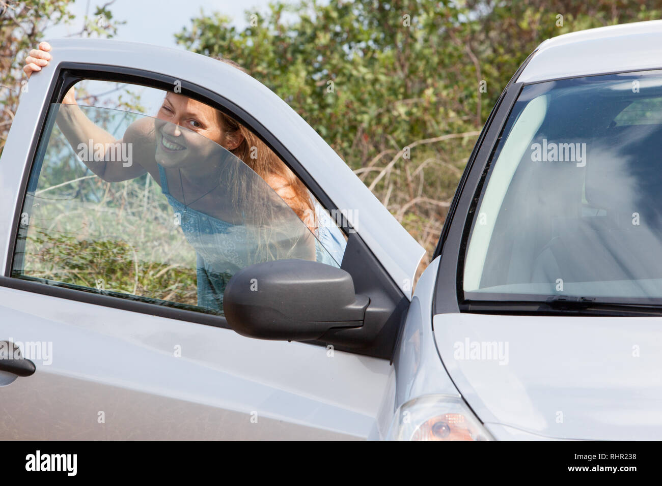 Female driving car looking behind hi-res stock photography and images ...