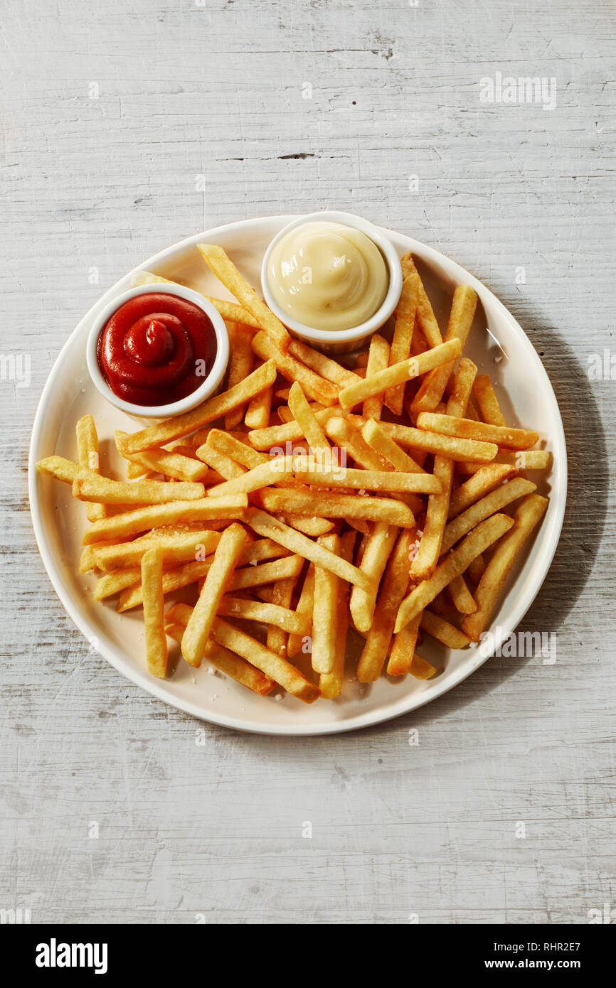 Plate of french fries potatoes served with ketchup and mayonnaise ...