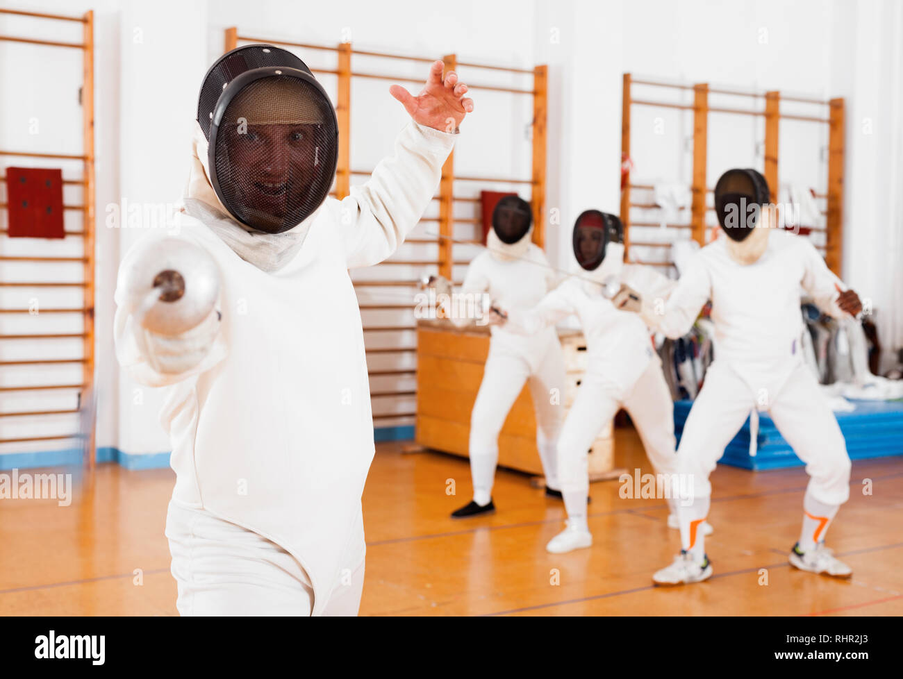 Sporty young glad cheerful positive smiling man fencer practicing ...
