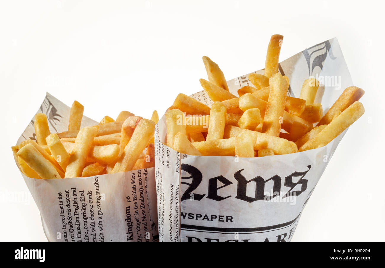 Two newspaper cones of French fries isolated on white in a fast food ...