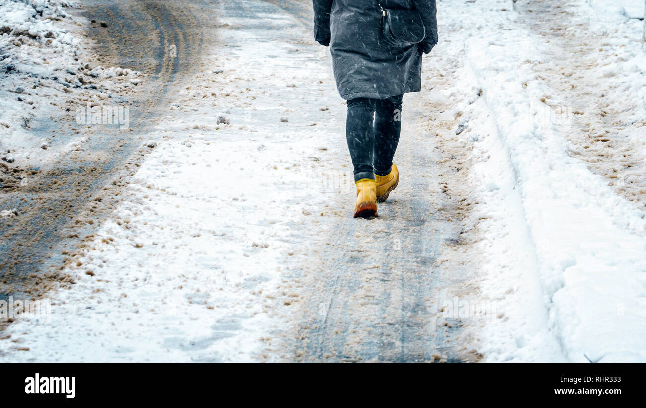 Winter Walk in Yellow Leather Boots. Back view on the feet of a women ...