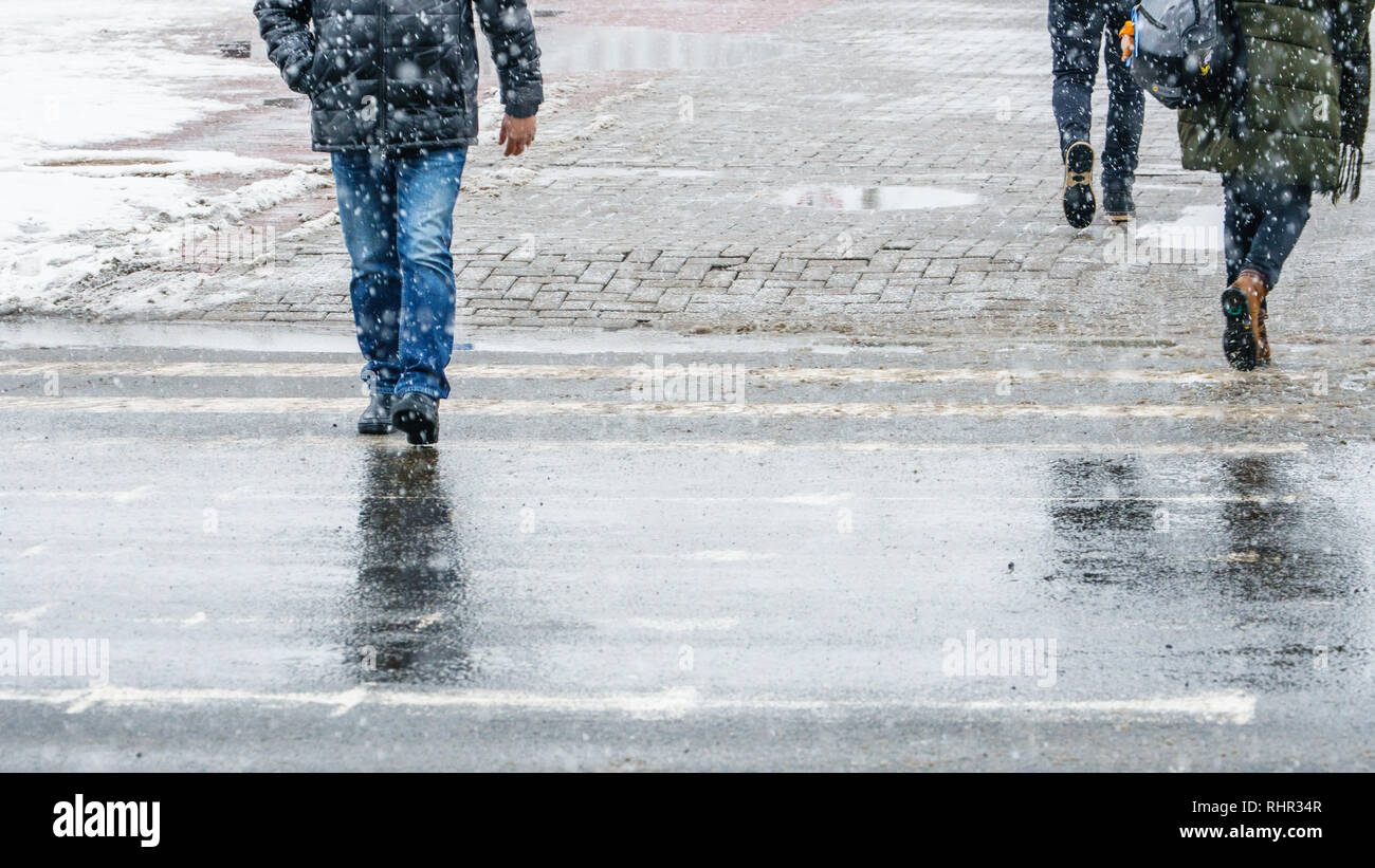 Winter City Slippery Sidewalk. Feet of people walking along the icy ...