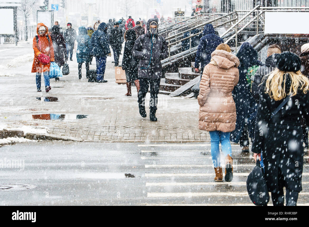 Blizzard in an Urban Environment. Crowd of Rushing People in crosswalk ...