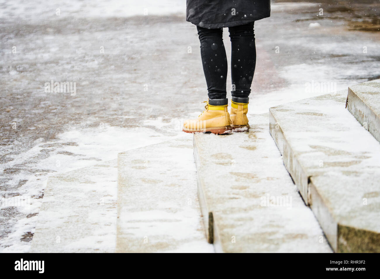 Winter Walk in Yellow Leather Boots. Back view on the feet of a women ...
