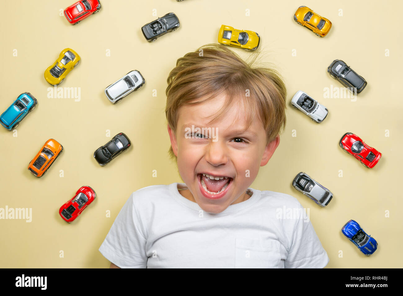 Young boy with colorful small car toys Stock Photo - Alamy