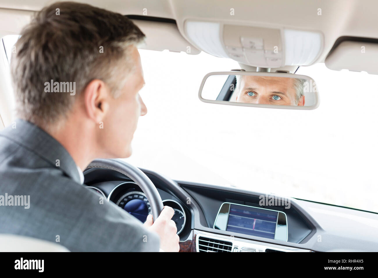 Man looking at rear view mirror car hi-res stock photography and images ...