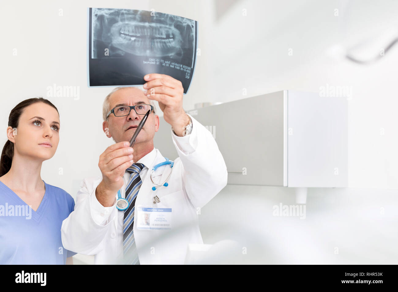 Colleagues examining medical x-ray at dental clinic Stock Photo - Alamy