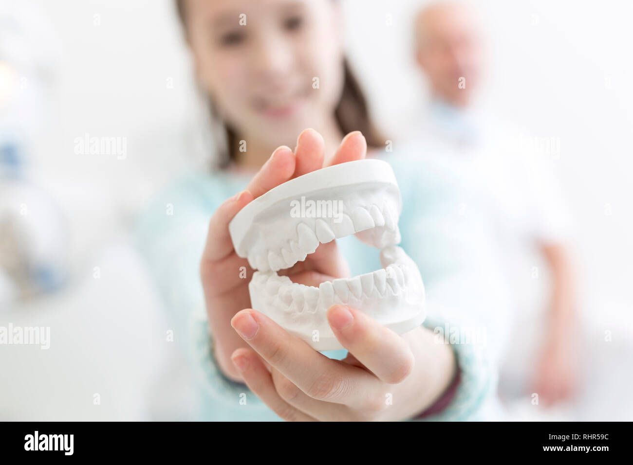 Closeup of girl showing dentures at dental clinic Stock Photo - Alamy