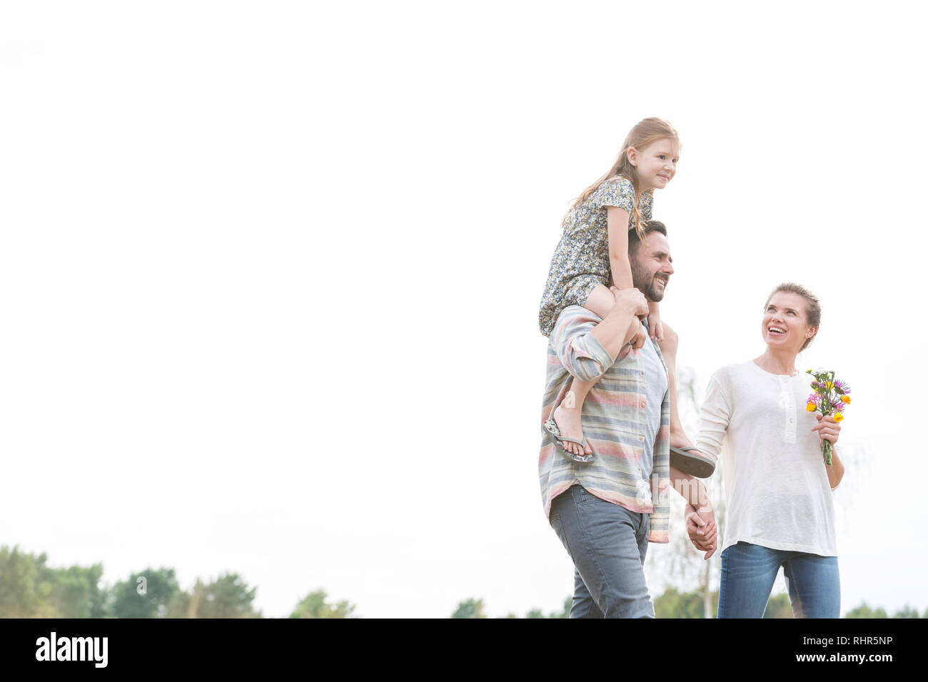 Low angle view of happy family at farm against sky Stock Photo - Alamy