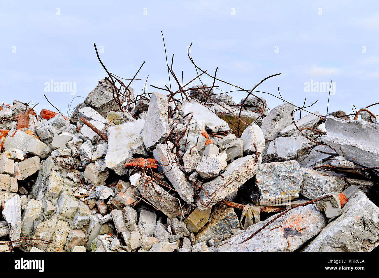The rebar sticking up from piles of brick rubble, stone and concrete ...