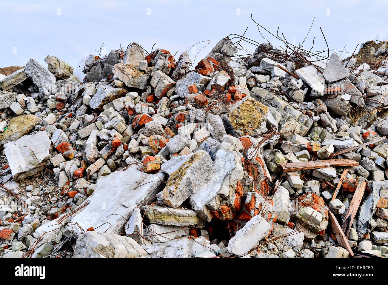 The rebar sticking up from piles of brick rubble, stone and concrete ...
