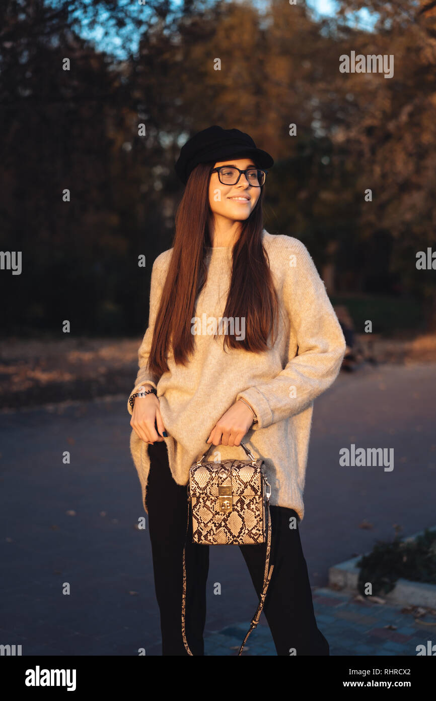 Attractive, young brunette with handbag posing for the camera Stock ...