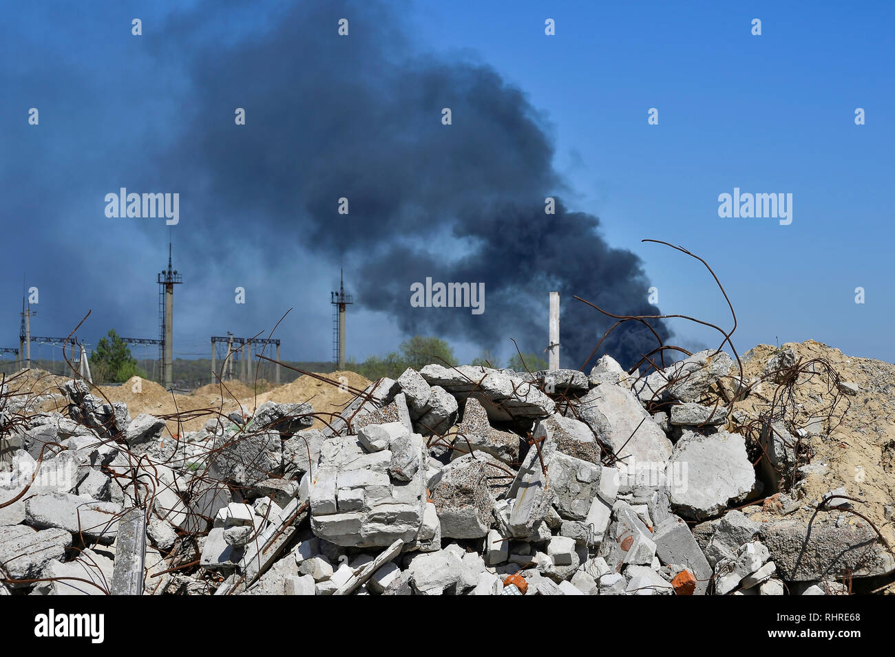A pile of concrete rubble with protruding rebar on the background of ...