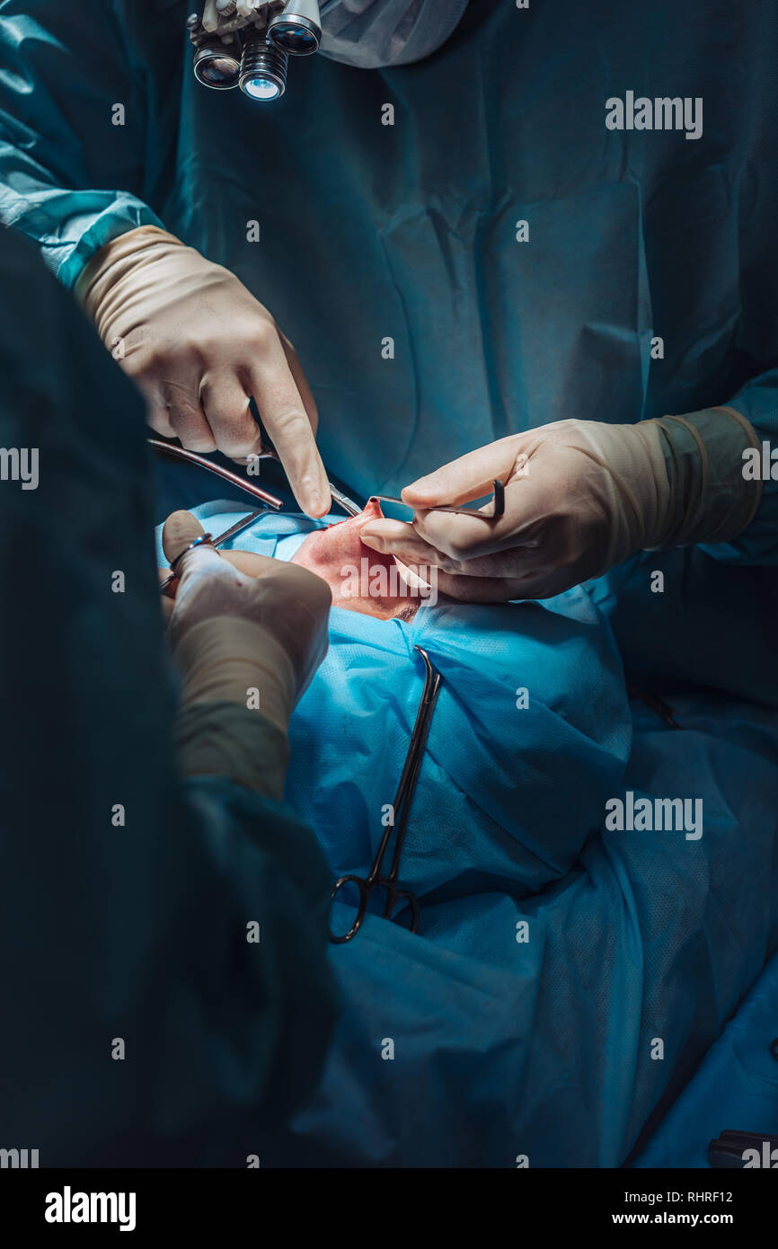 Cosmetic surgery on nose. The surgeon cuts the flesh Stock Photo - Alamy