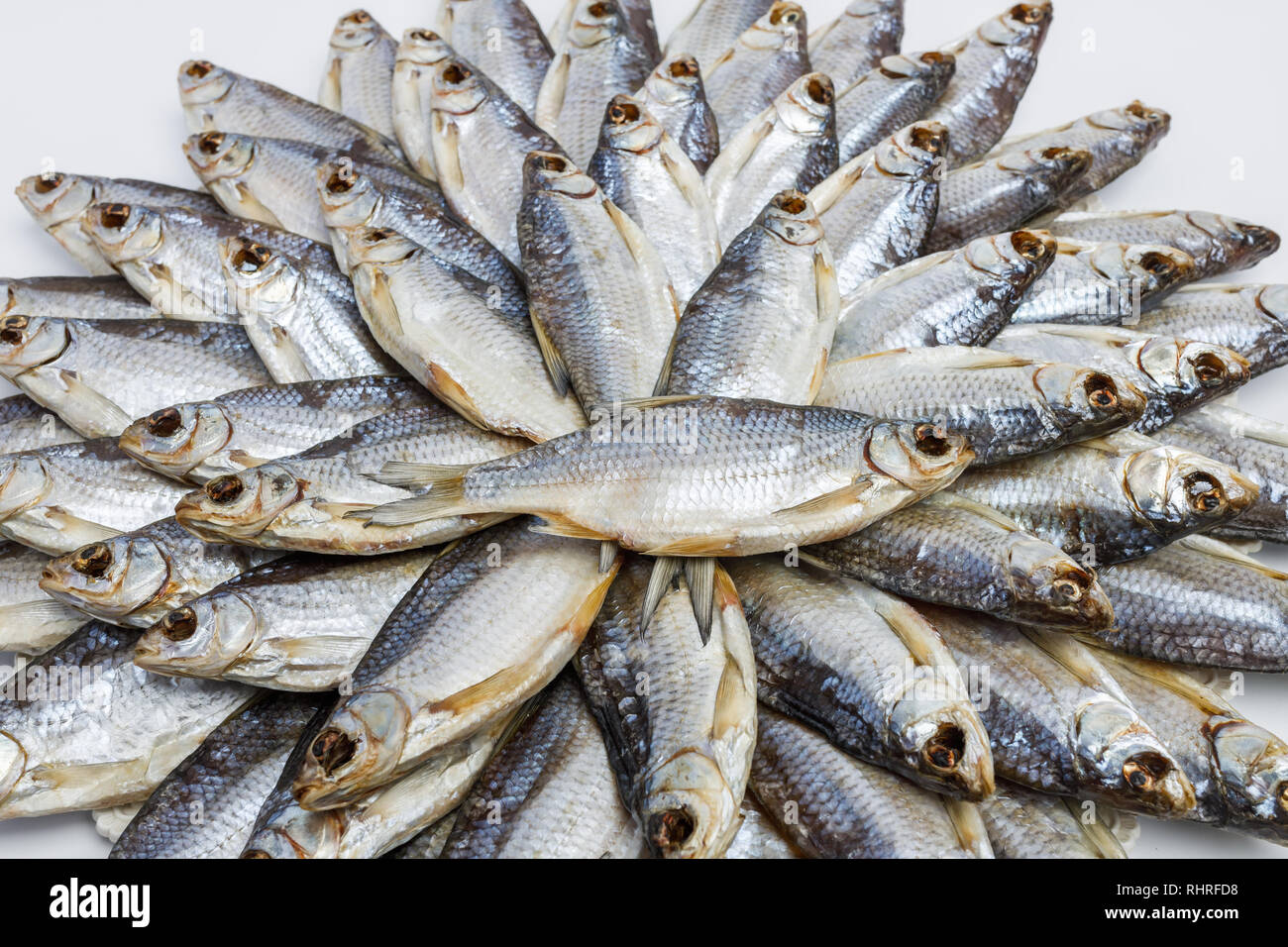 Big heap of dried salted sea roach on a white background Stock Photo ...