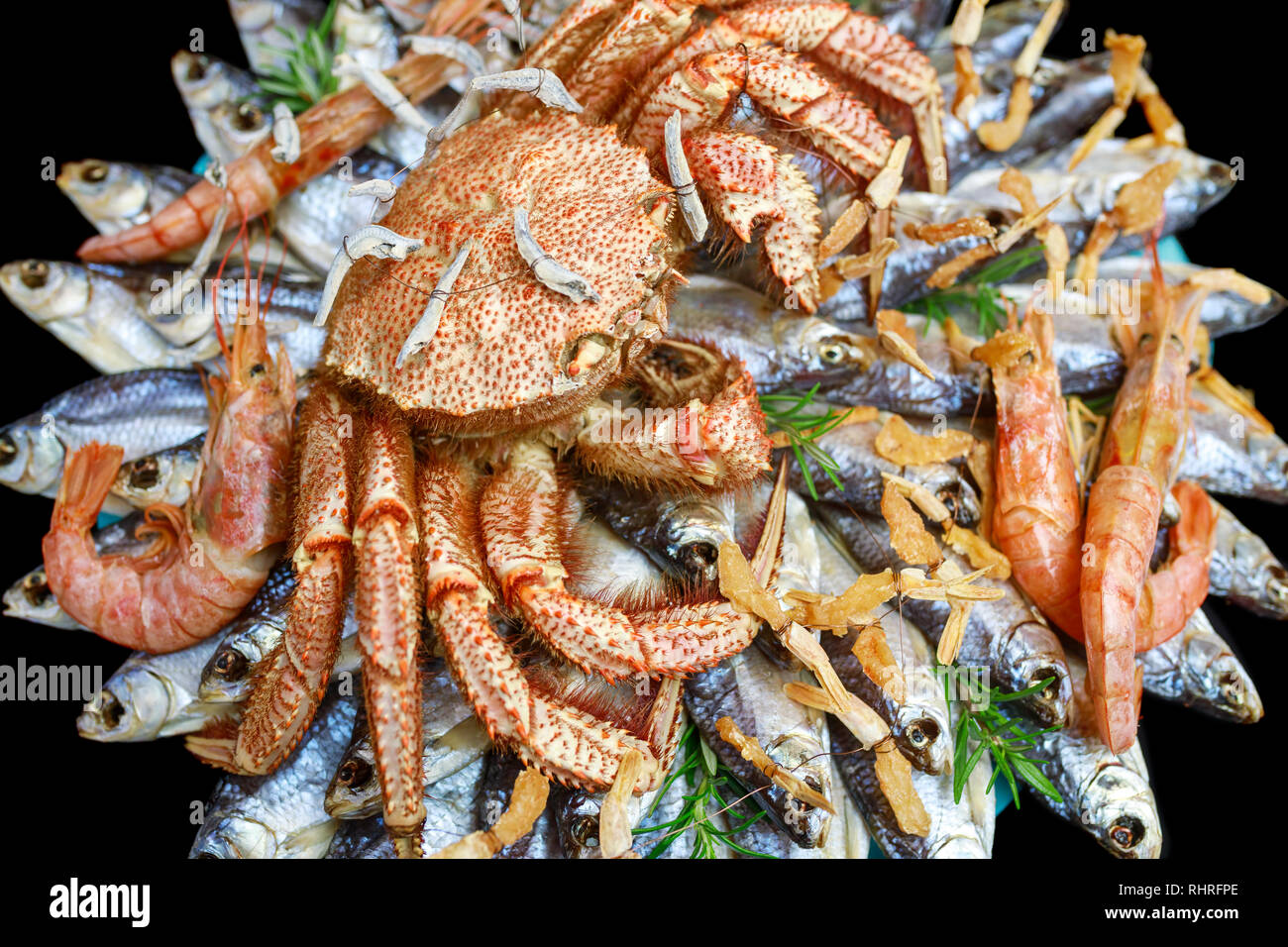 Big hairy boiled crab sits on a heap of dried salted fish on a gift ...