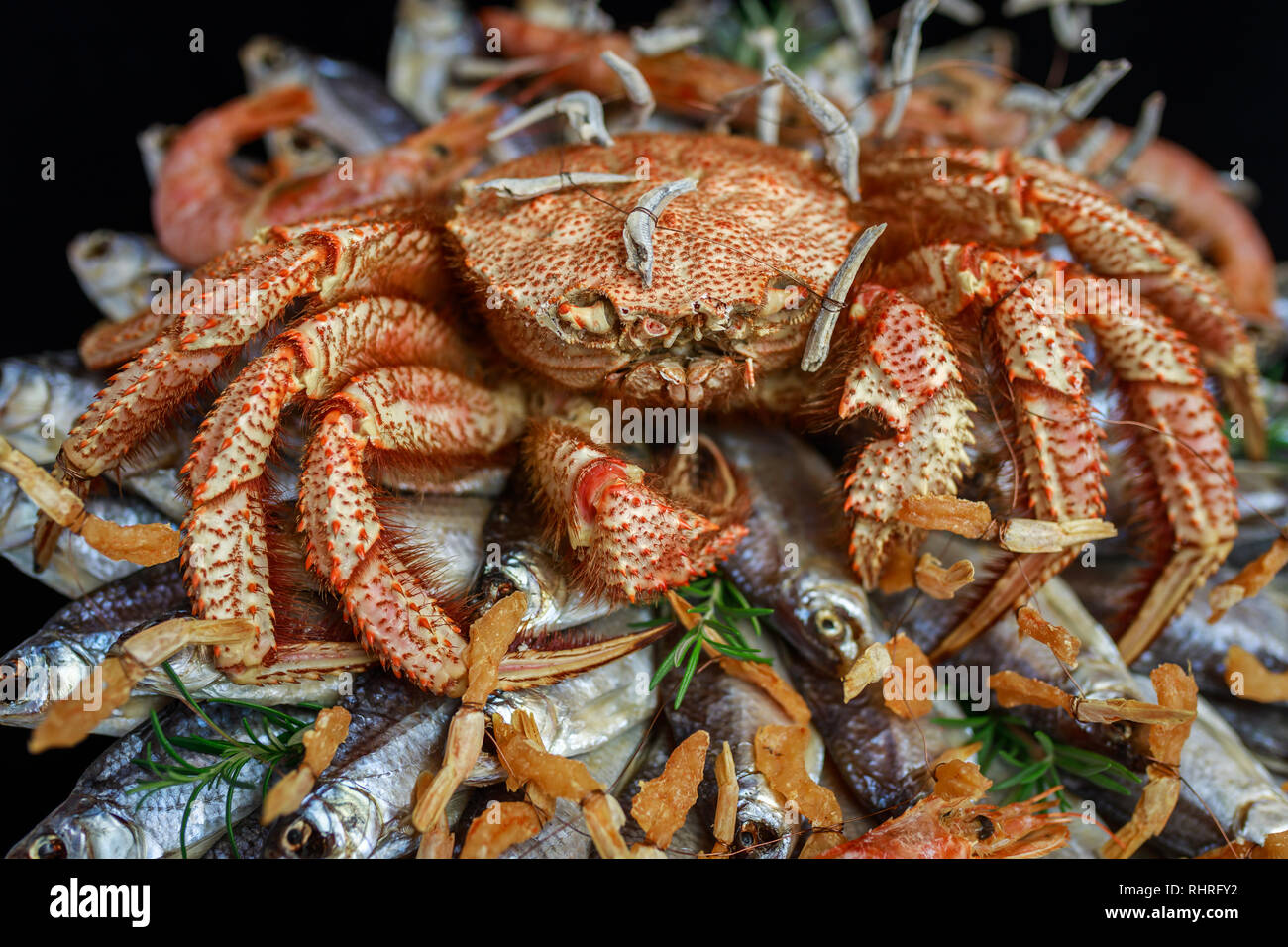 Big hairy boiled crab sits on a heap of dried salted fish on a gift ...