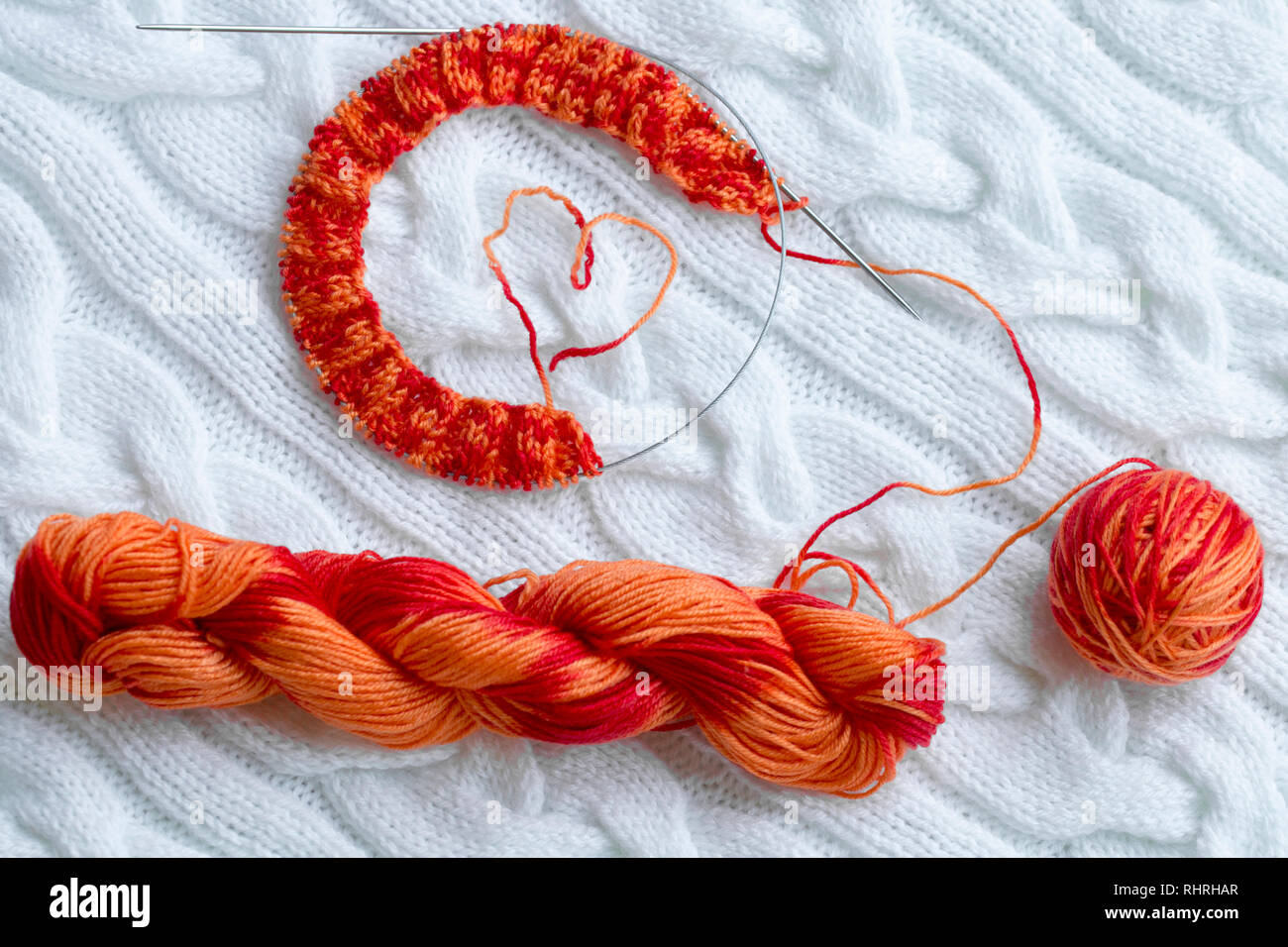 Knitting project in progress. A piece of knitting with a ball and a ...