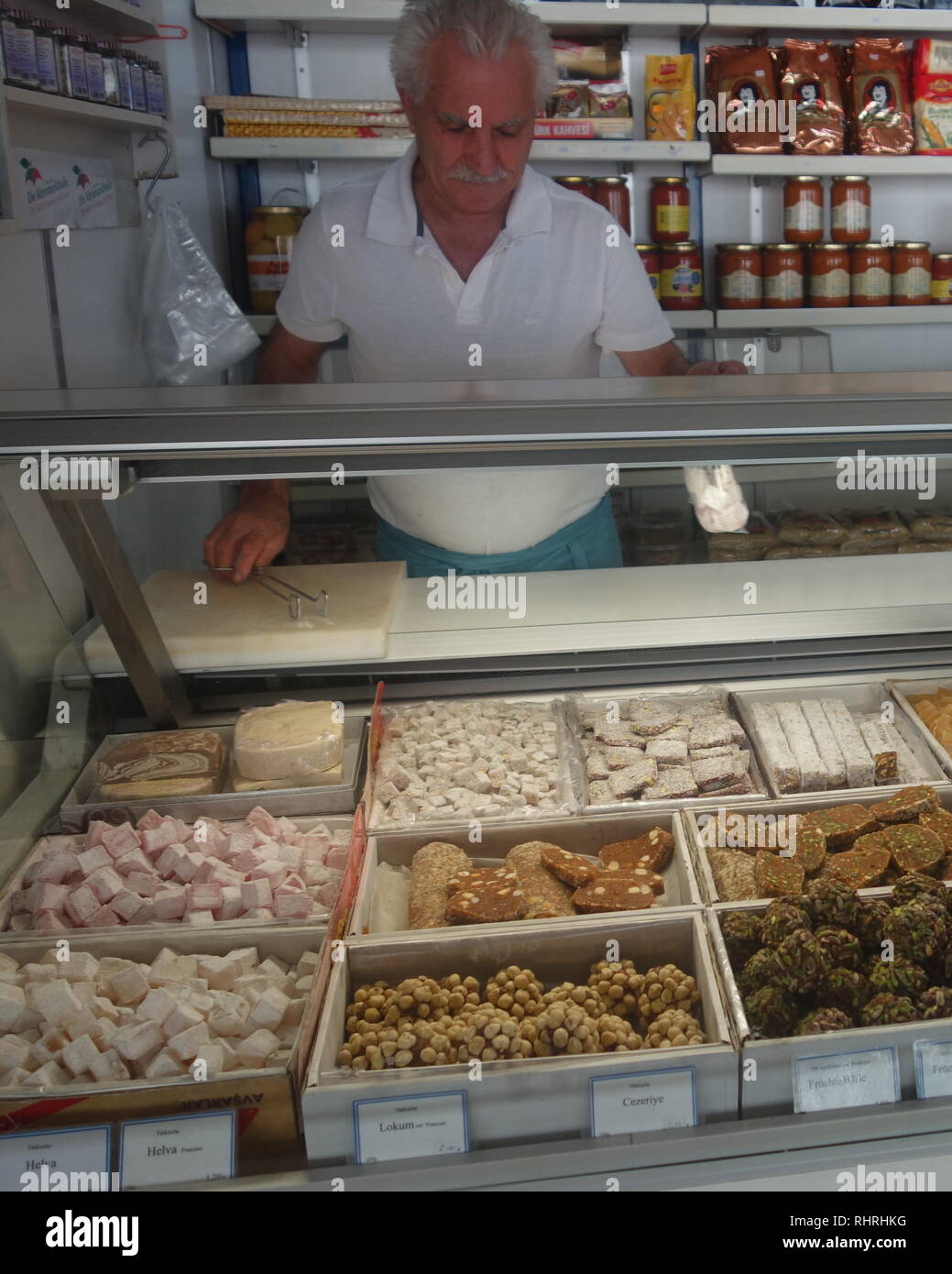 A sweet vendor selling Turkish sweets from his market stall in the ...