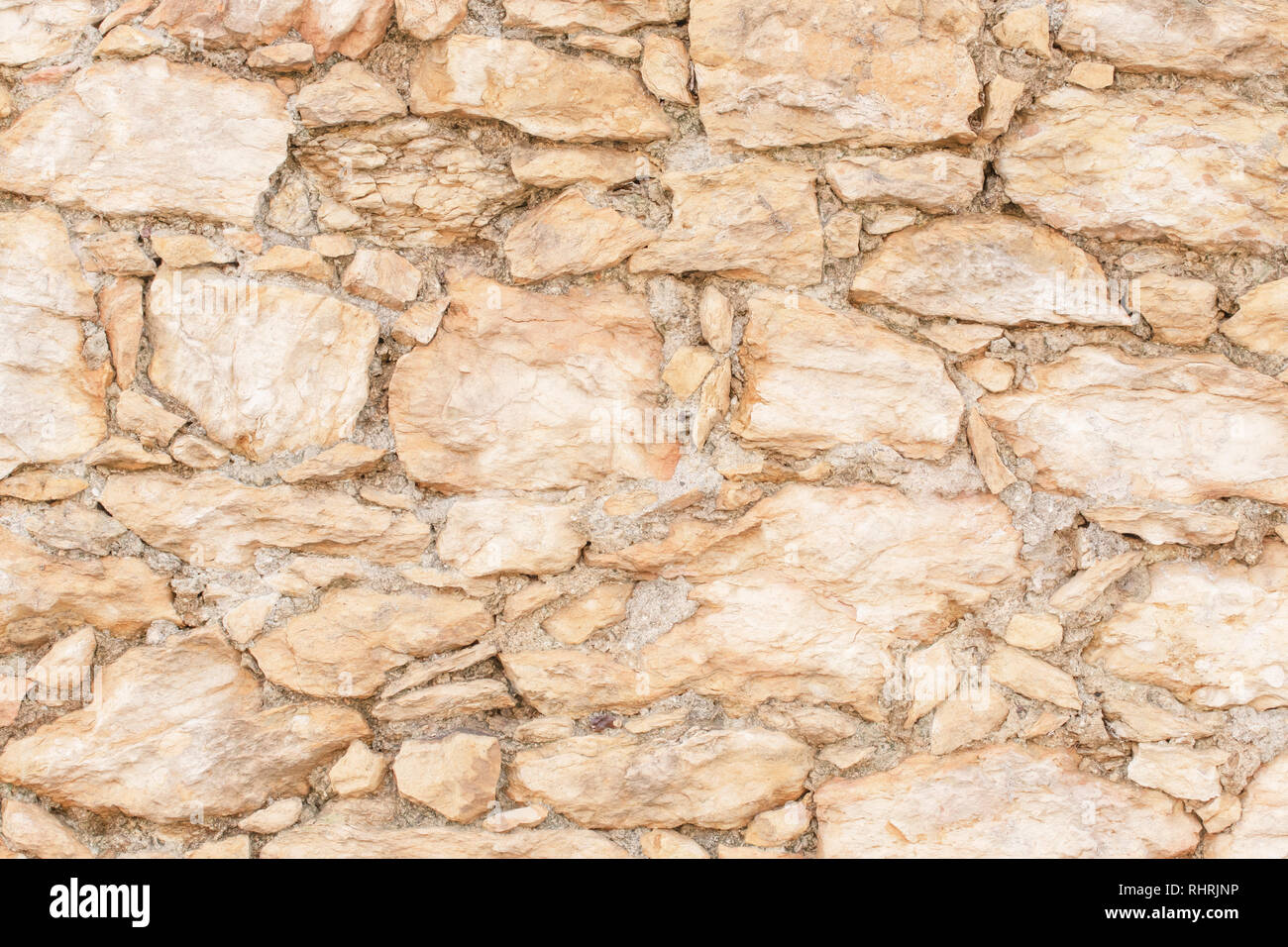 Background texture of a stone wall in Spain for design and inscriptions ...