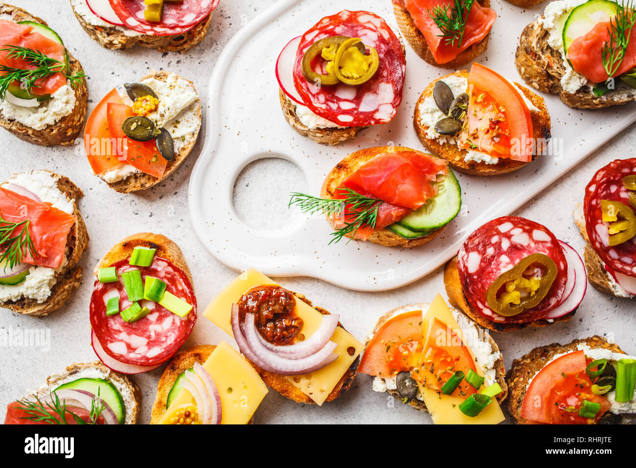 Assorted spanish tapas with fish, sausage, cheese and vegetables. White ...