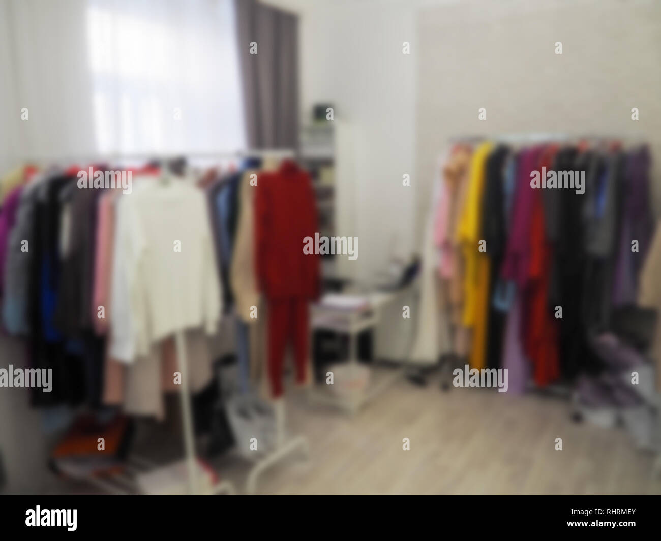 blurred clothes on hanger in clothing store. Abstract blur and ...