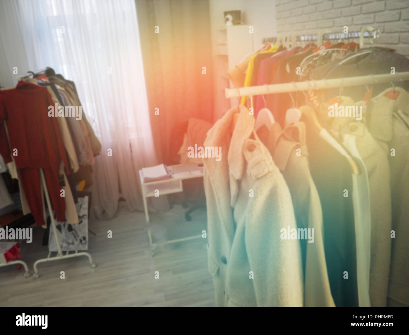 blurred clothes on hanger in clothing store. Abstract blur and ...