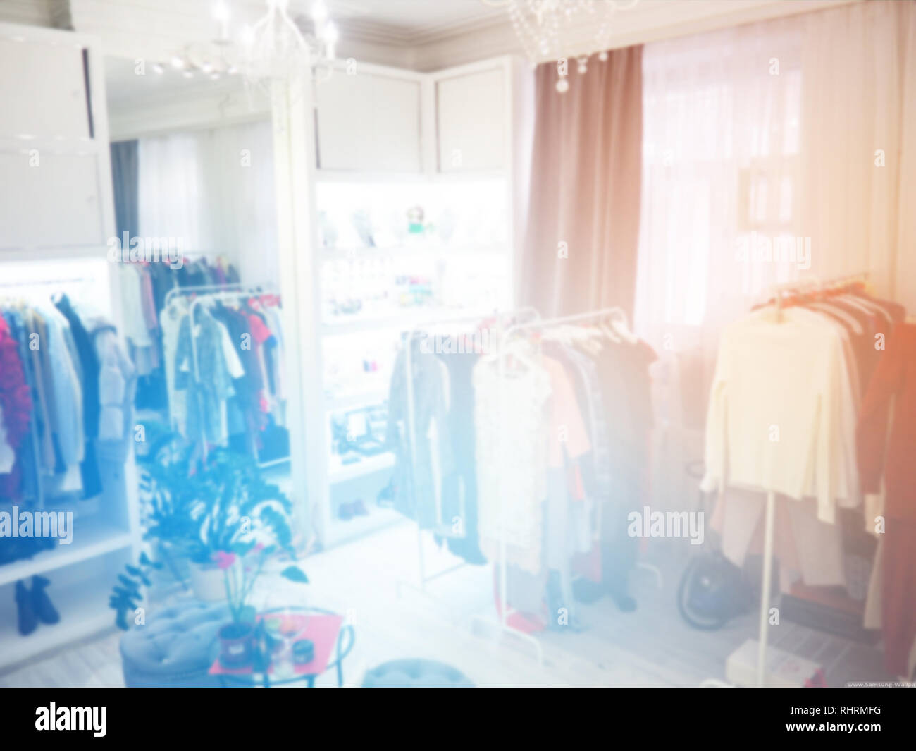 blurred clothes on hanger in clothing store. Abstract blur and ...