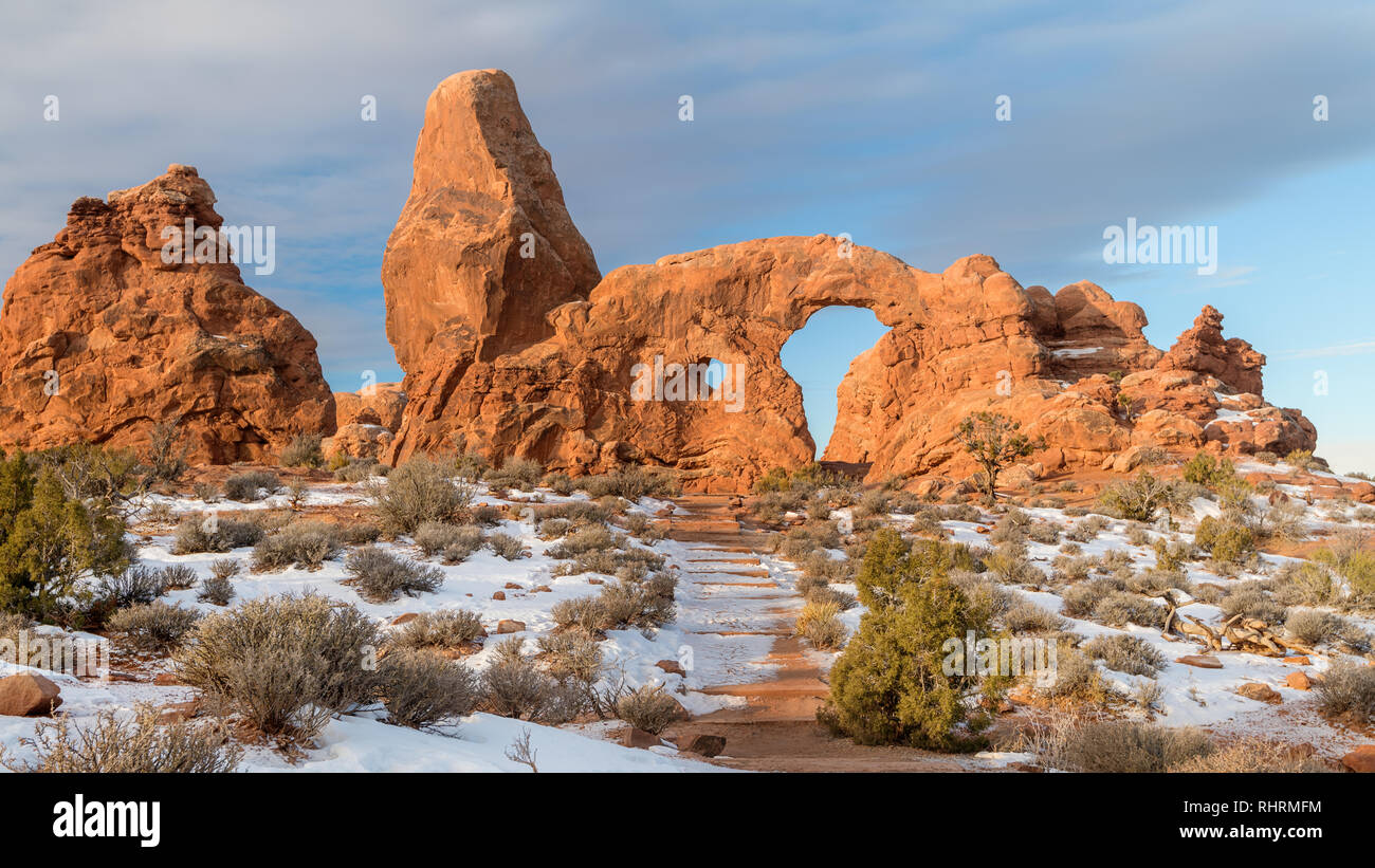 Arches National Park in winter with a foot path leading to one of the ...