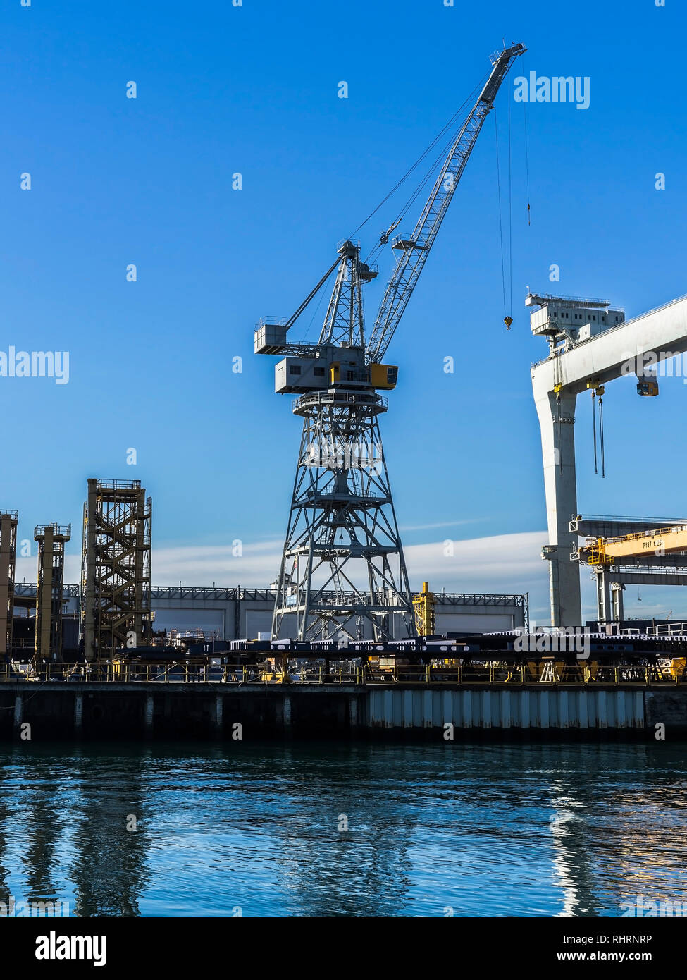 Shipyard construction crane in low light waiting for cargo to be lifted ...