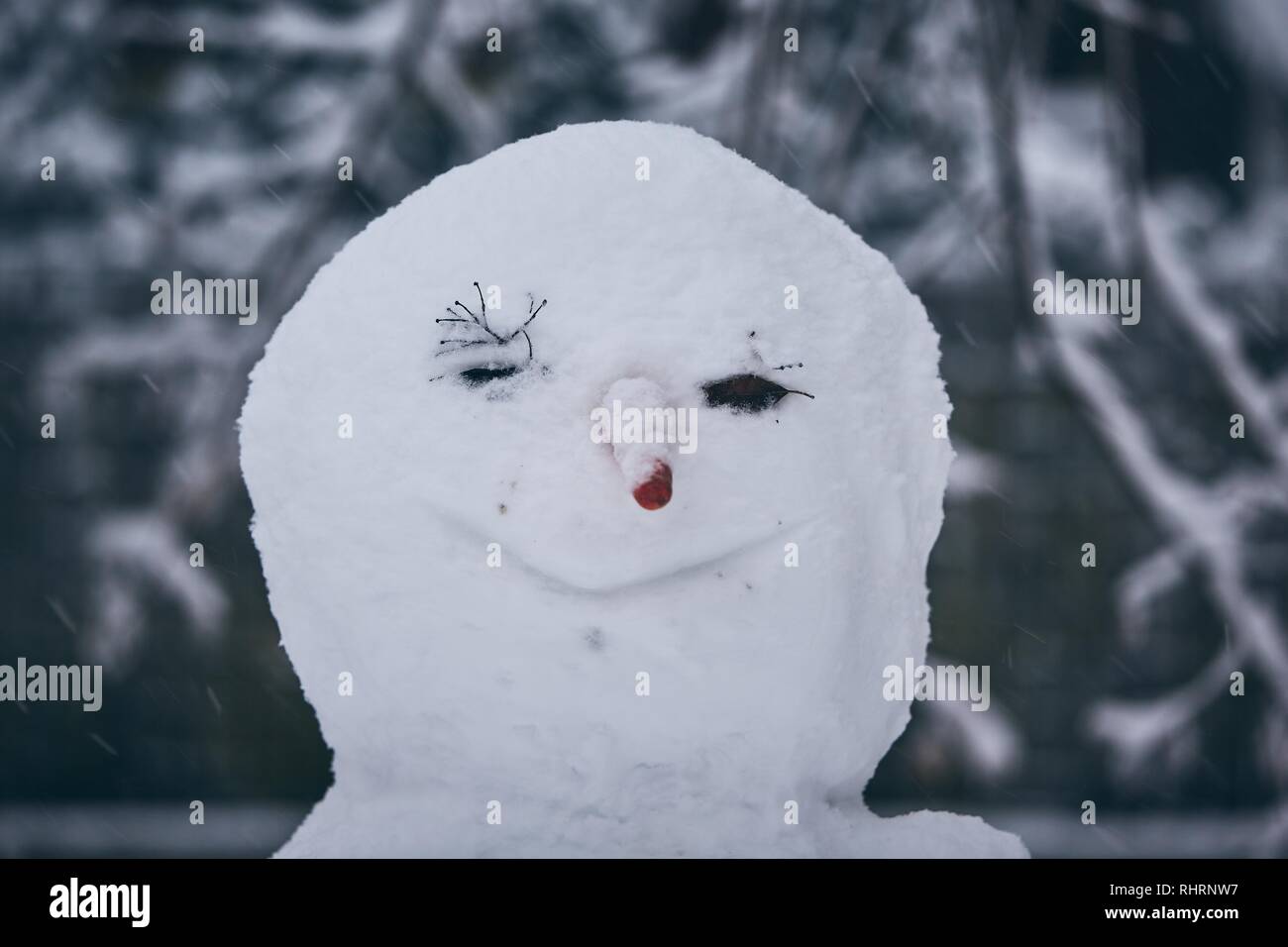 Winter in the city. Head of big snowman during snowfall Stock Photo - Alamy