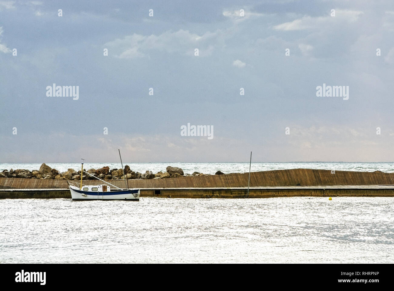 Mediterranean sea view with pier against dark skies with dramatic light ...