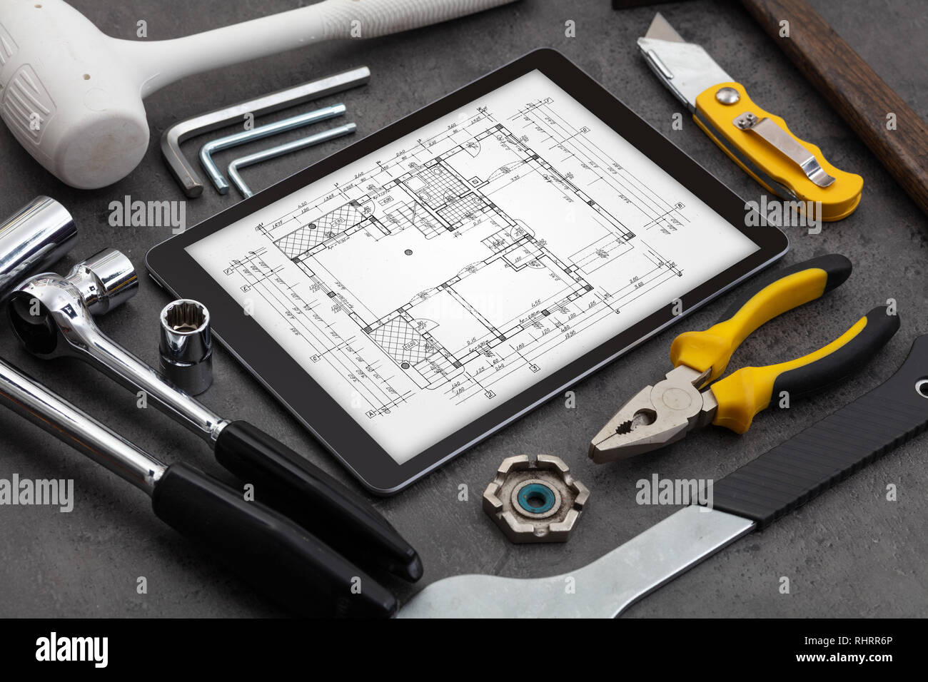 Tablet with construction tools and blueprint concept Stock Photo - Alamy