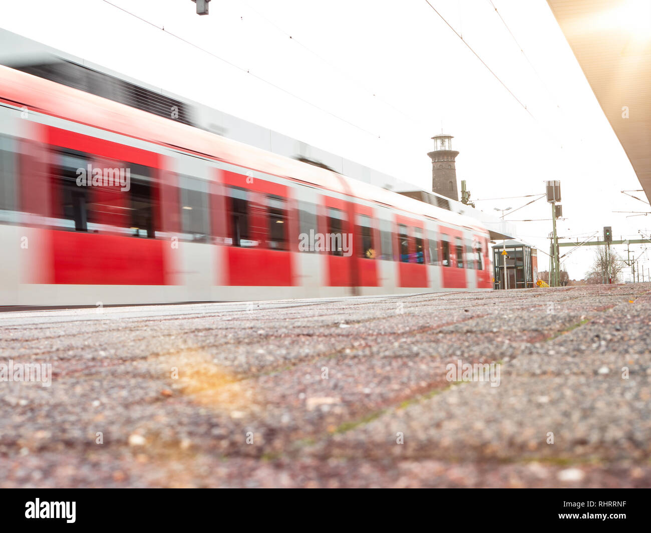 rail platform with red commuter train in motion blur in Cologne ...
