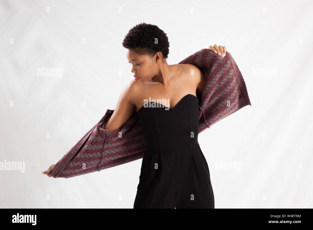Lovely black woman opening her jacket Stock Photo - Alamy