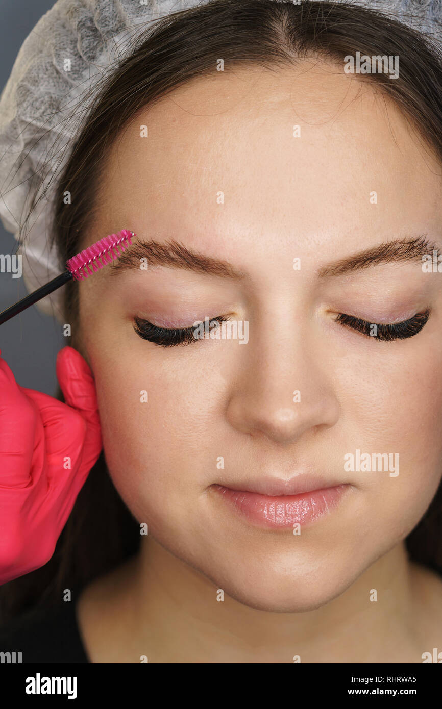 Eyebrow correction. Combing eyebrows and giving direction of hair ...