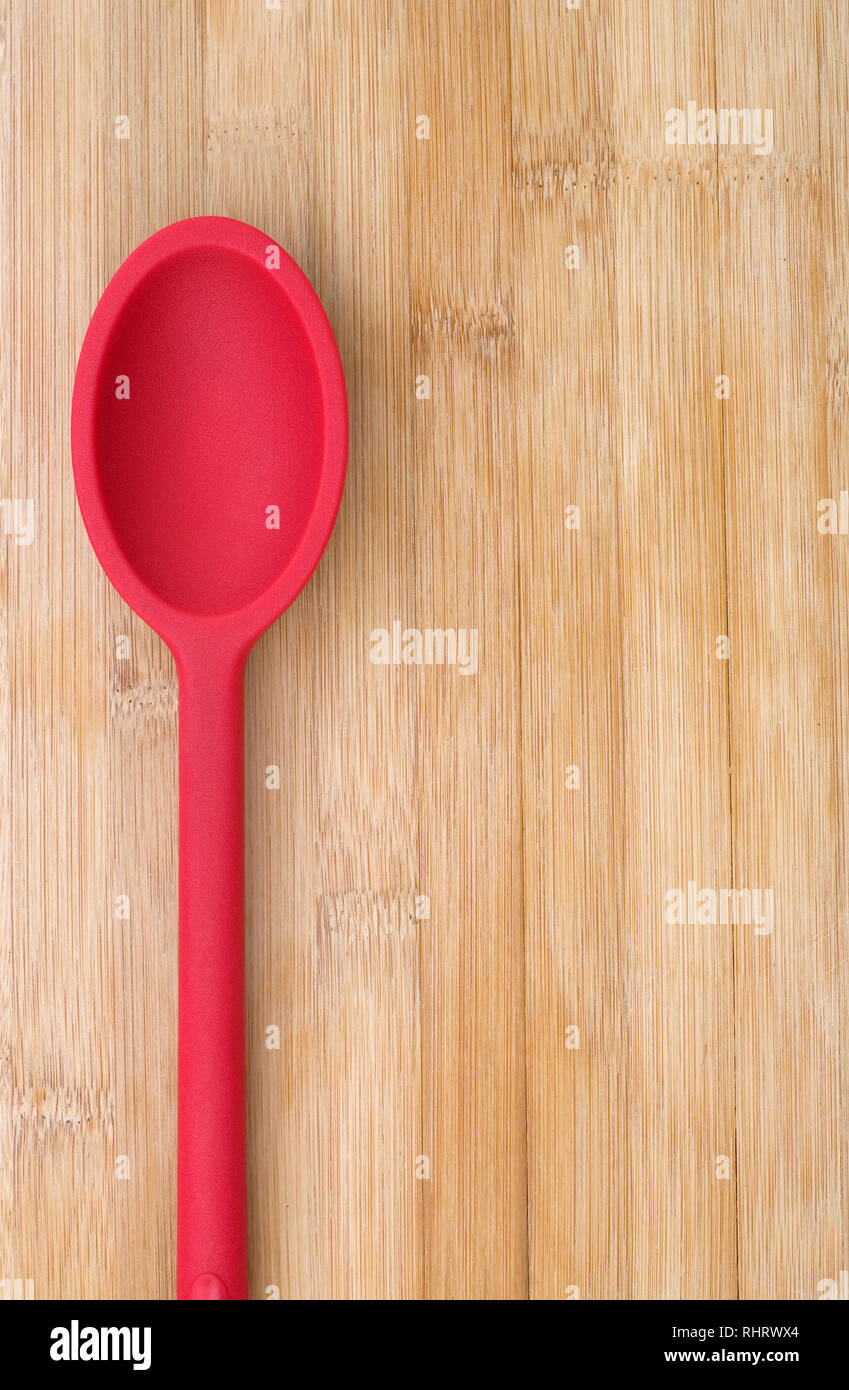 Red Rubber Utensils for the Kitchen on wood Background Stock Photo - Alamy