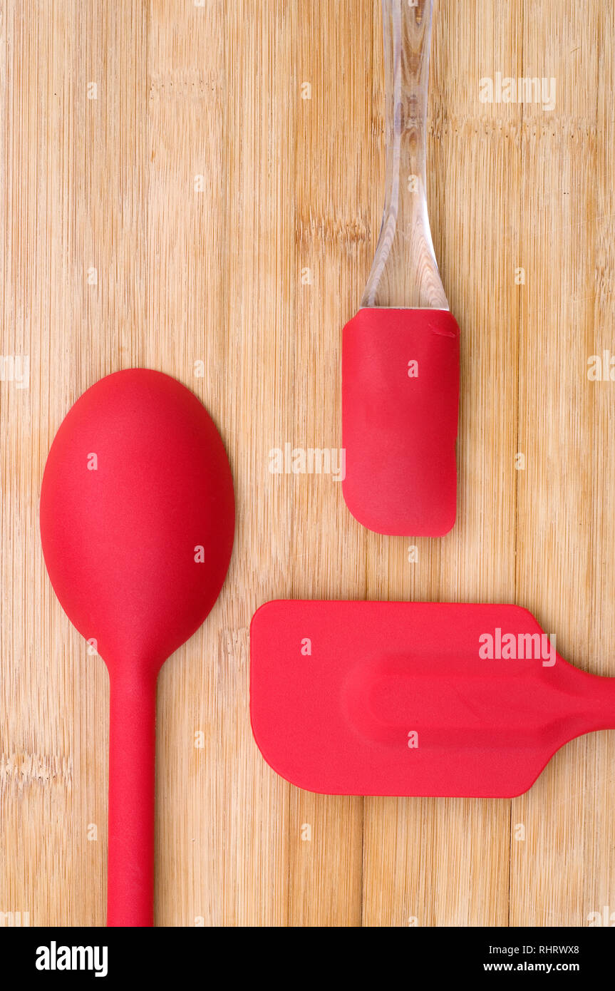 Red Rubber Utensils for the Kitchen on wood Background Stock Photo - Alamy