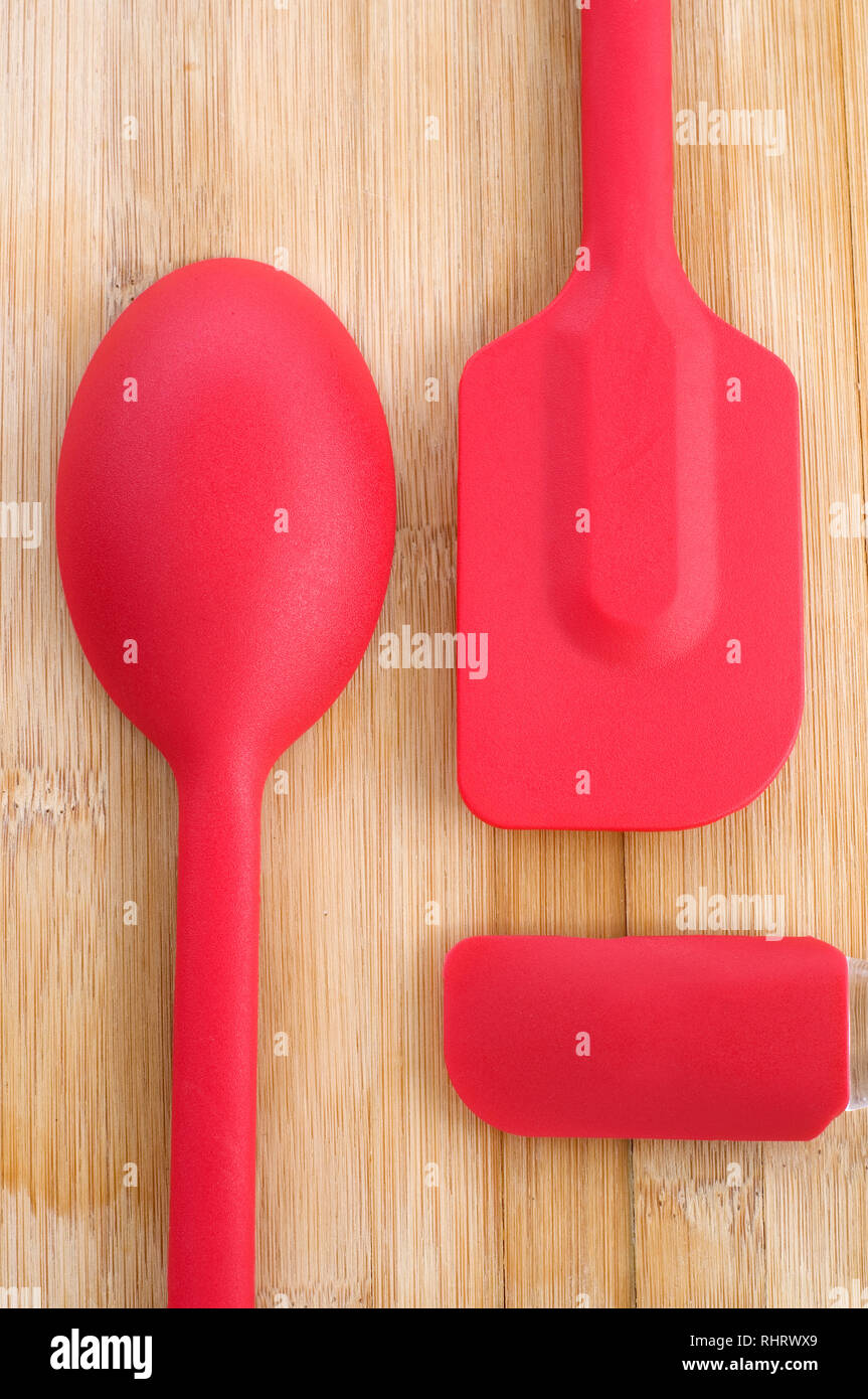Red Rubber Utensils for the Kitchen on wood Background Stock Photo - Alamy