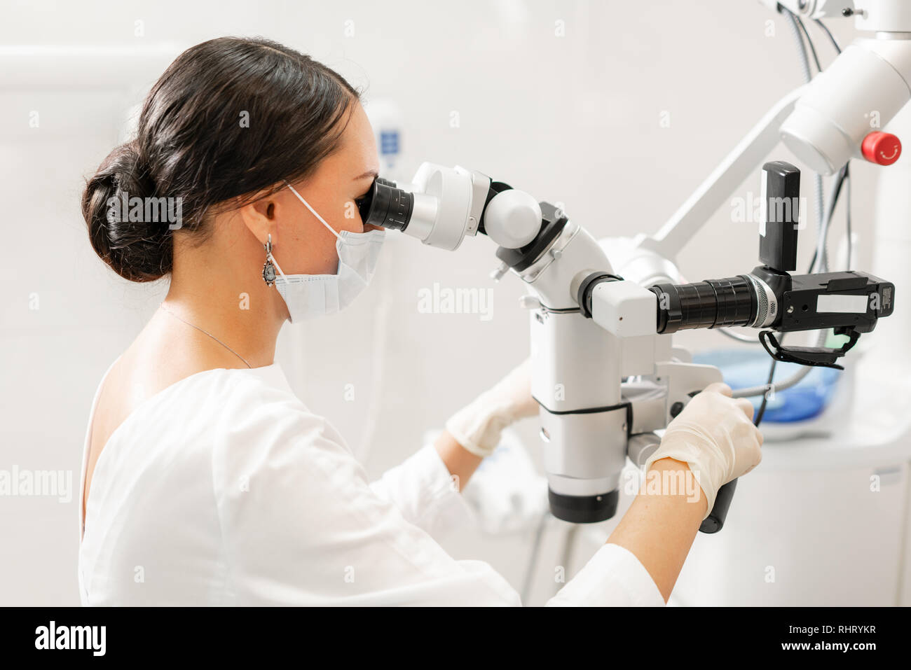 Female dentist advanced user, dental tools. Looking into the lens of a ...