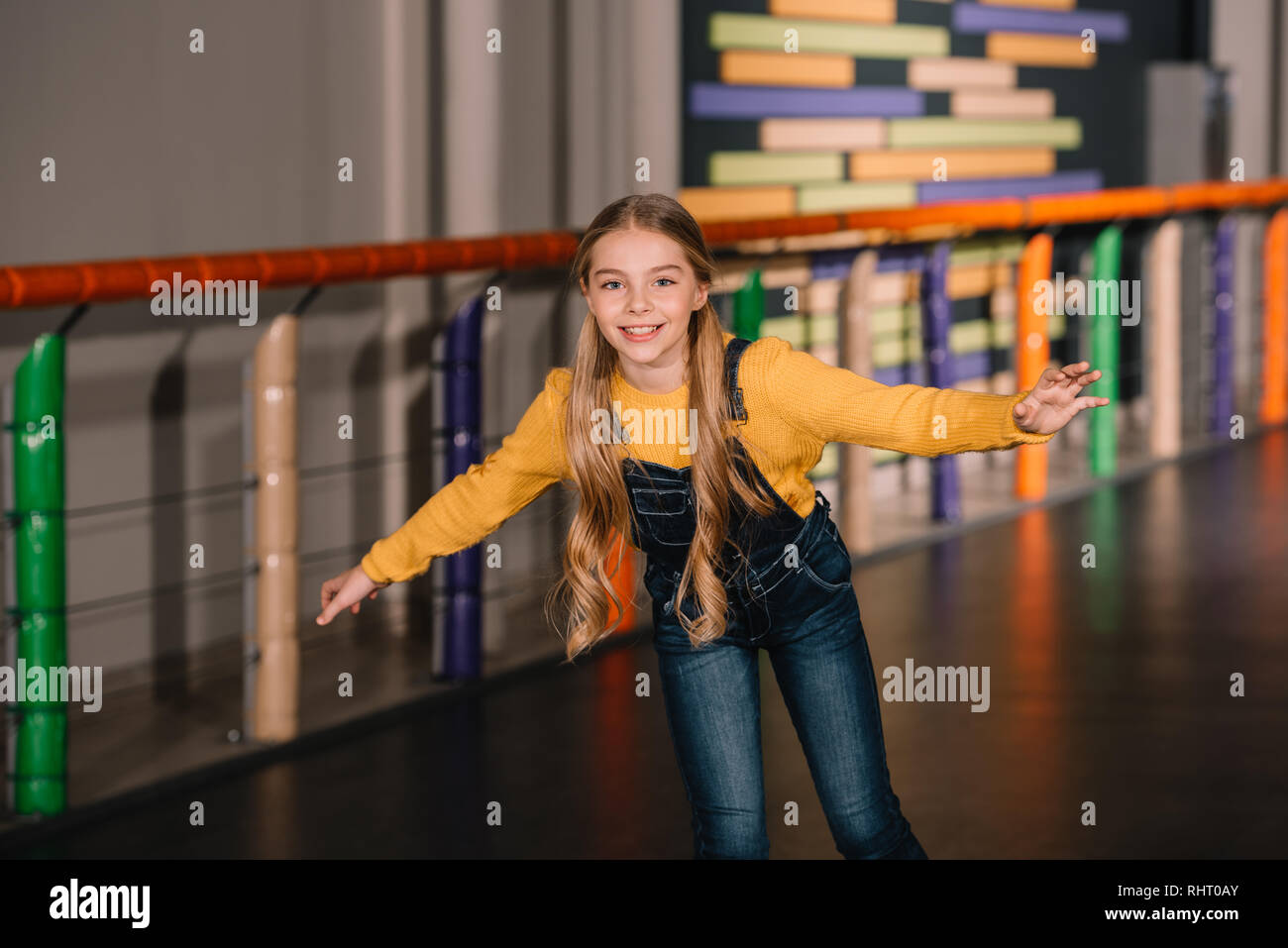 Active kid with long hair posing on roller rink Stock Photo - Alamy