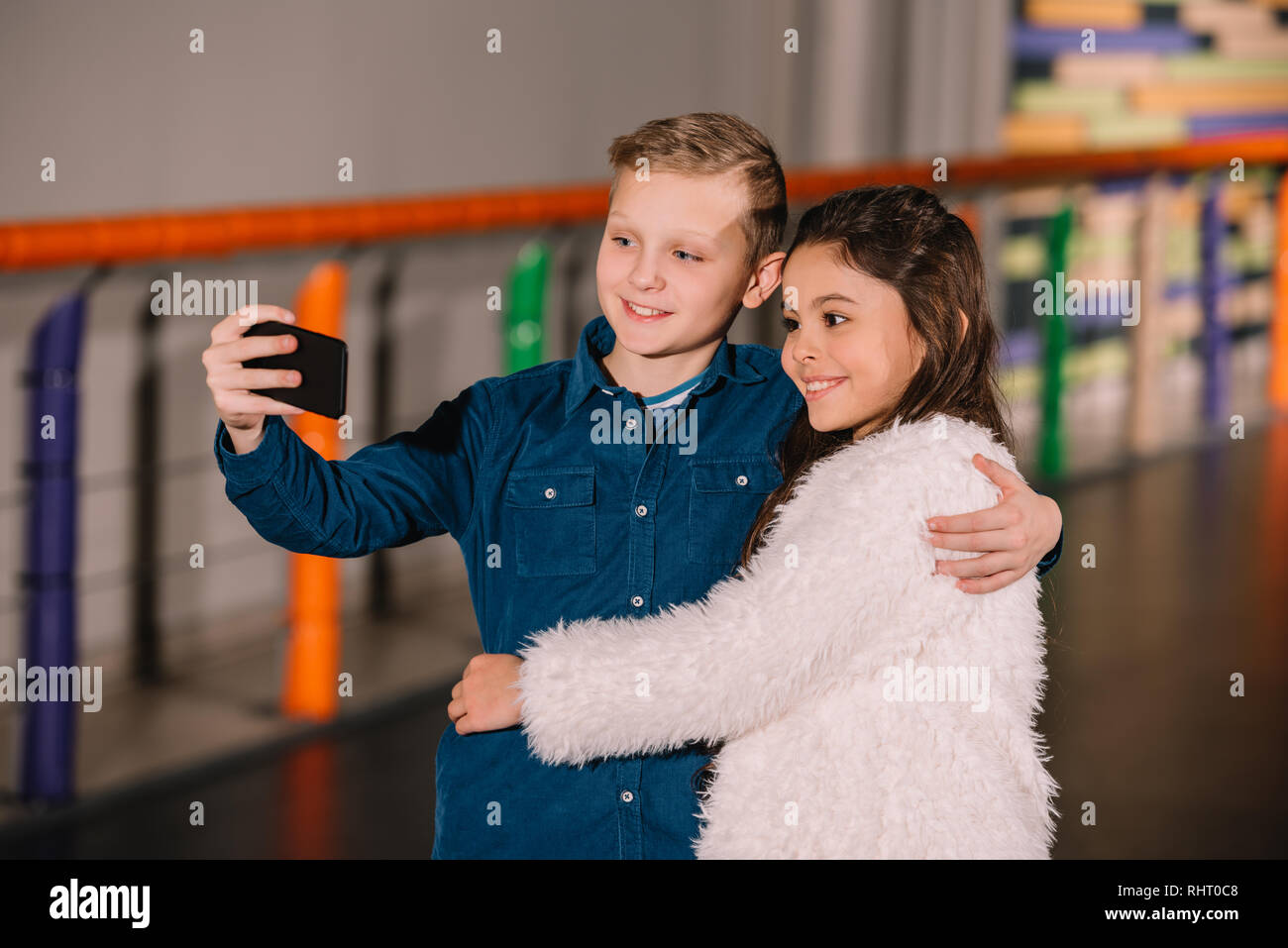 Kid hugs with friend and making selfie Stock Photo - Alamy