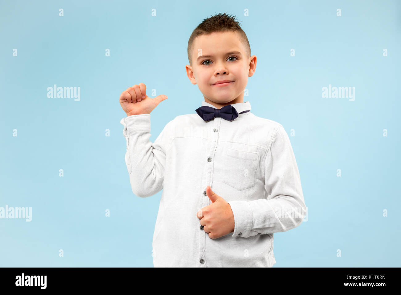 Happy teen boy smiling isolated on blue studio background. Beautiful ...