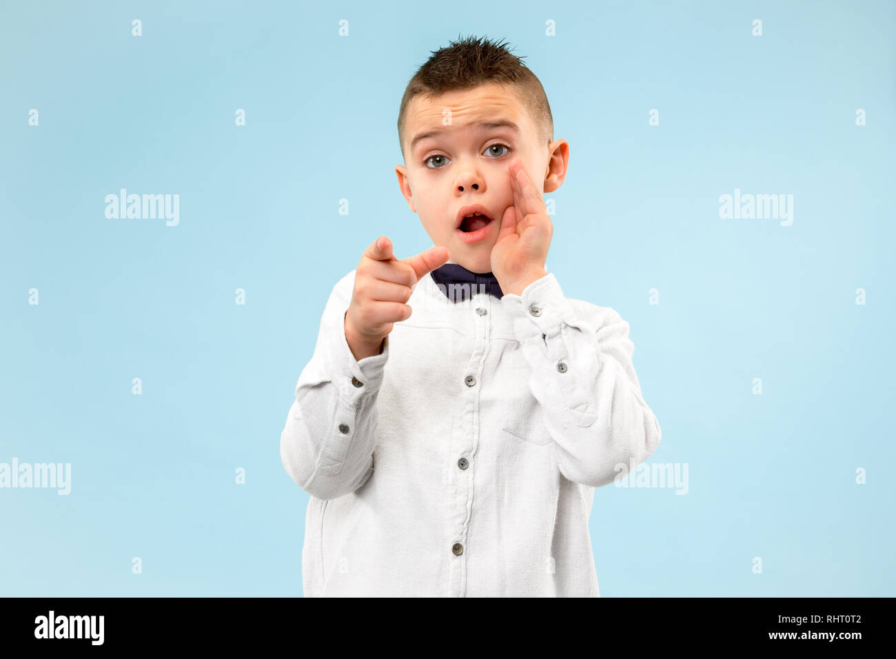 Secret, gossip concept. Teen boy whispering a secret behind his hand ...